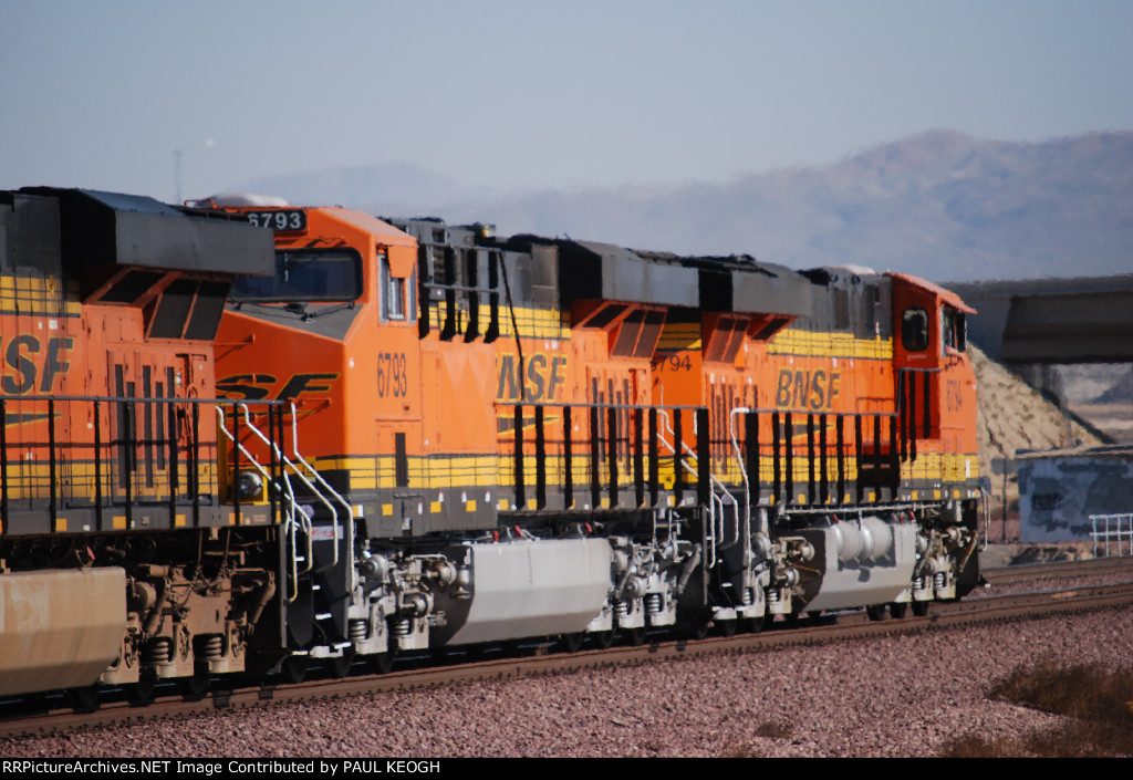 BNSF 6793 and BNSF 6794 head into the yard in this zoom shot of them.